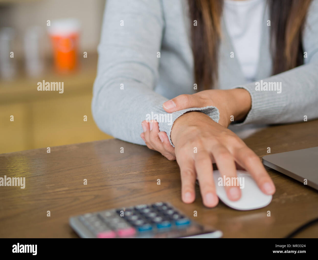 Closeup woman holding her wrist pain from using computer long time ...