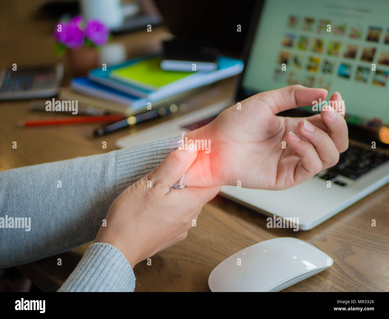 Closeup woman holding her wrist pain from using computer long time ...