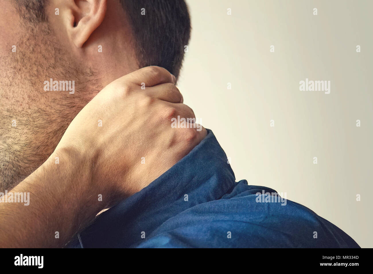 Man with neck pain. young guy holding his neck. a sore neck. chondrosis ...