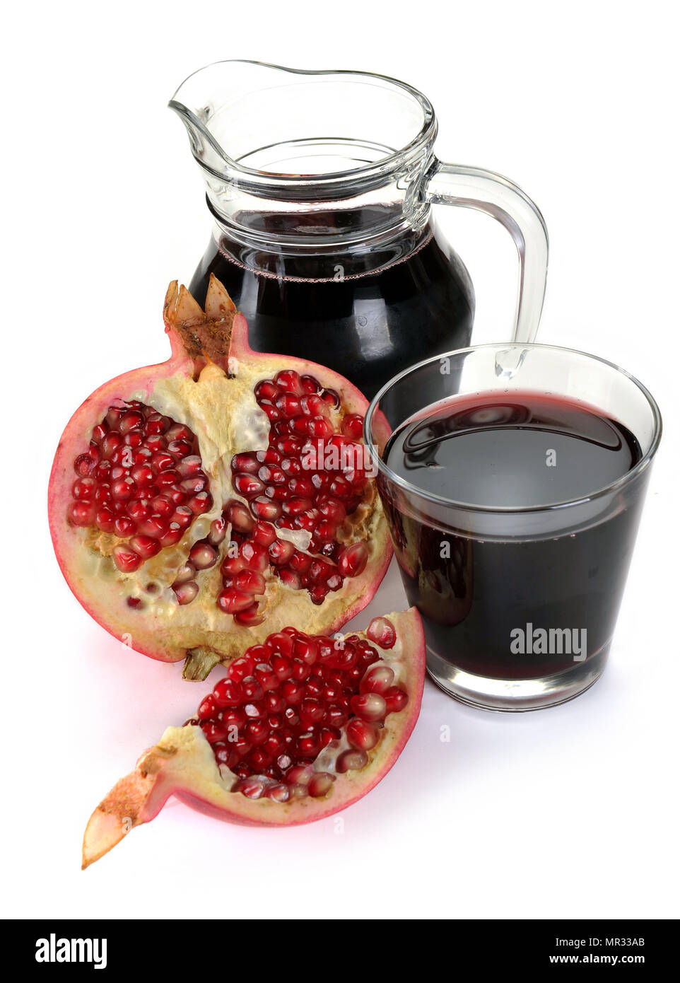 Jug of juice and ripe piece grenade on white background Stock Photo - Alamy