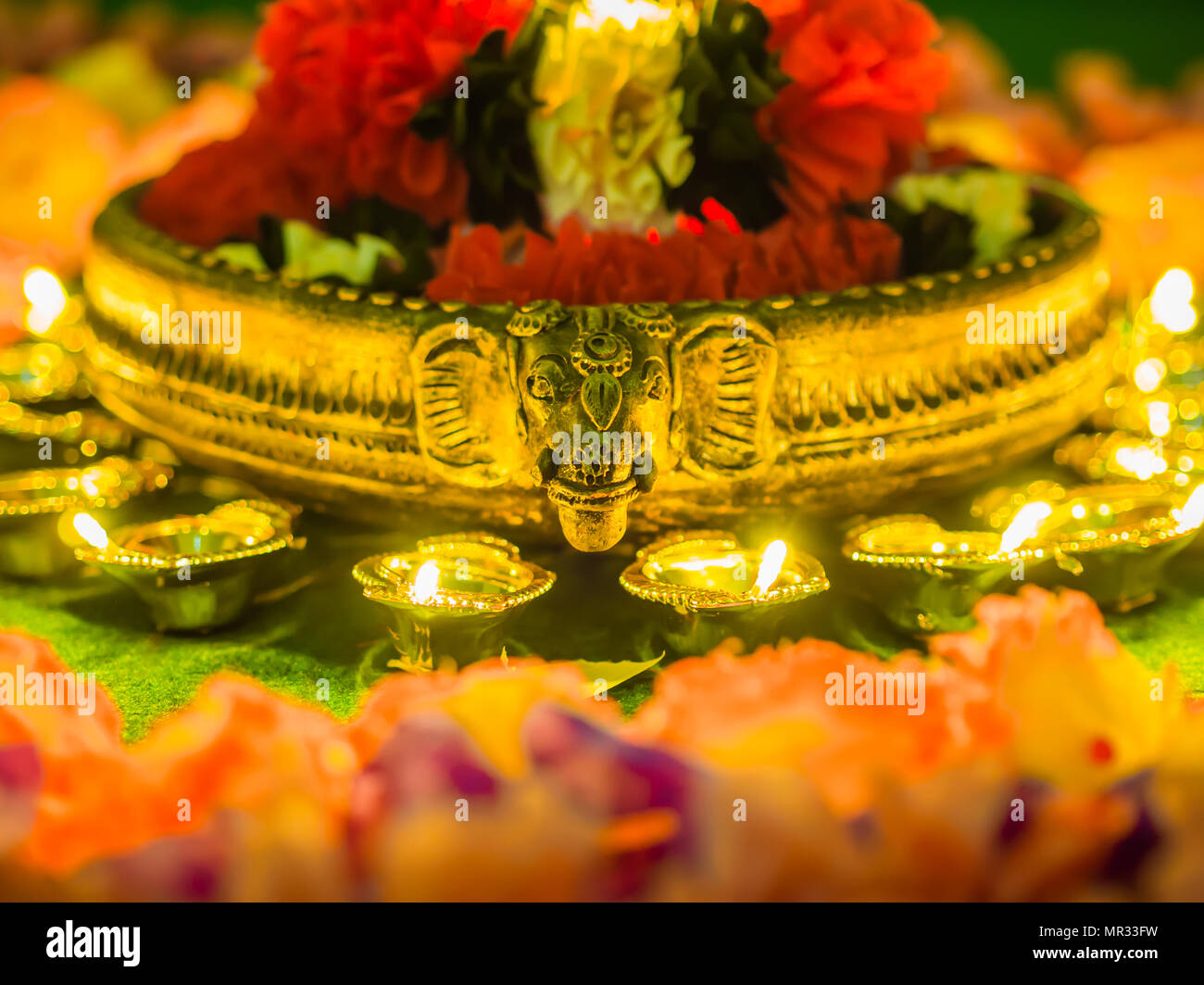 Traditional clay diya lamps lit with flowers for Diwali festival ...