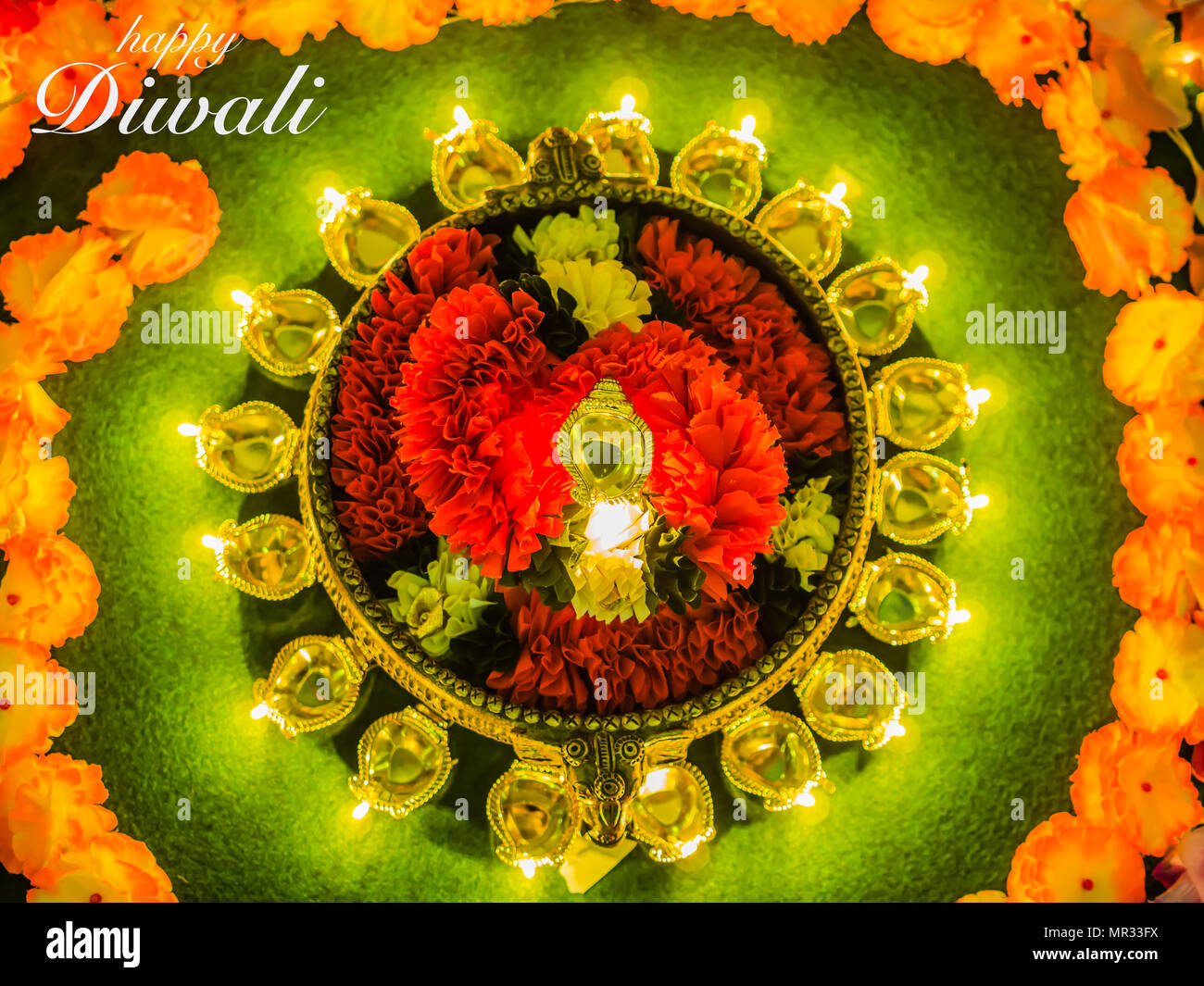 Traditional clay diya lamps lit with flowers for Diwali festival ...