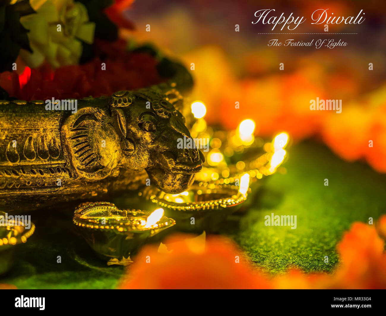 Traditional clay diya lamps lit with flowers for Diwali festival ...