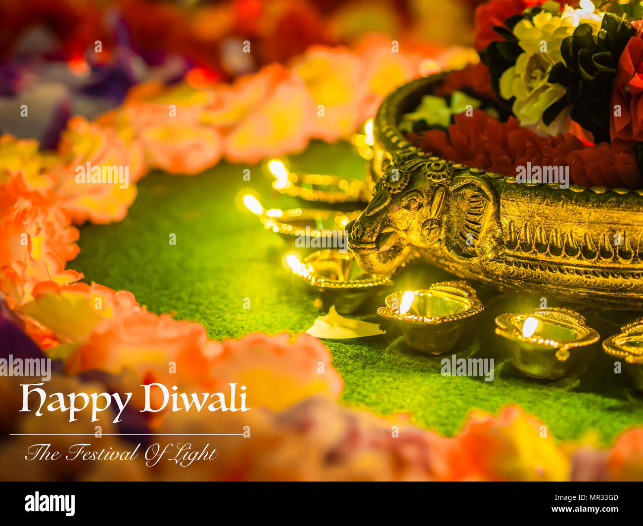 Traditional clay diya lamps lit with flowers for Diwali festival ...