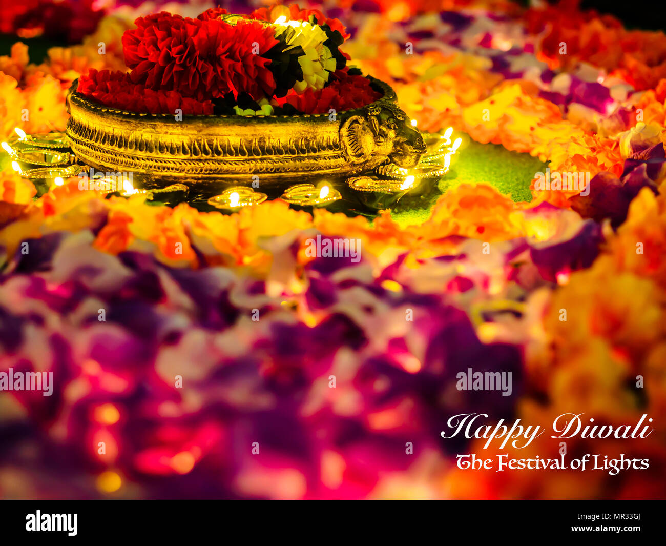 Traditional clay diya lamps lit with flowers for Diwali festival ...