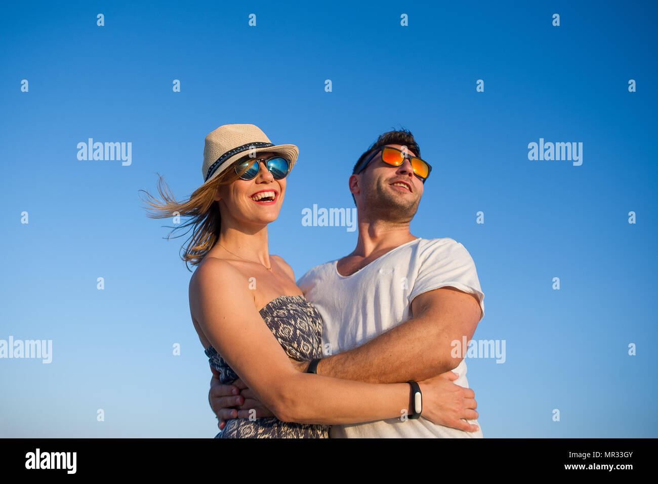 Beautiful young couple against the background of the blue sky. Lovers ...