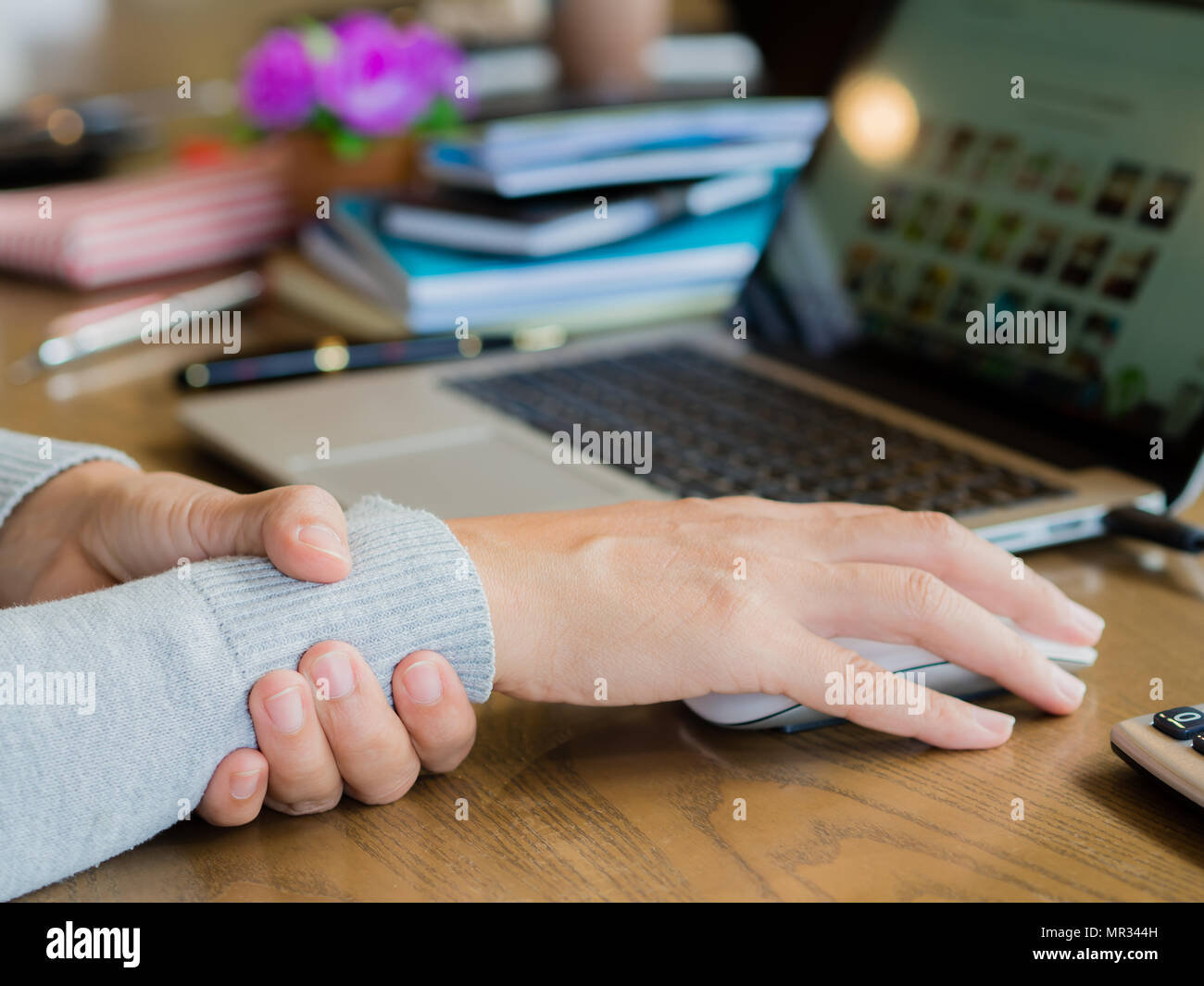 Closeup woman holding her wrist pain from using computer long time ...