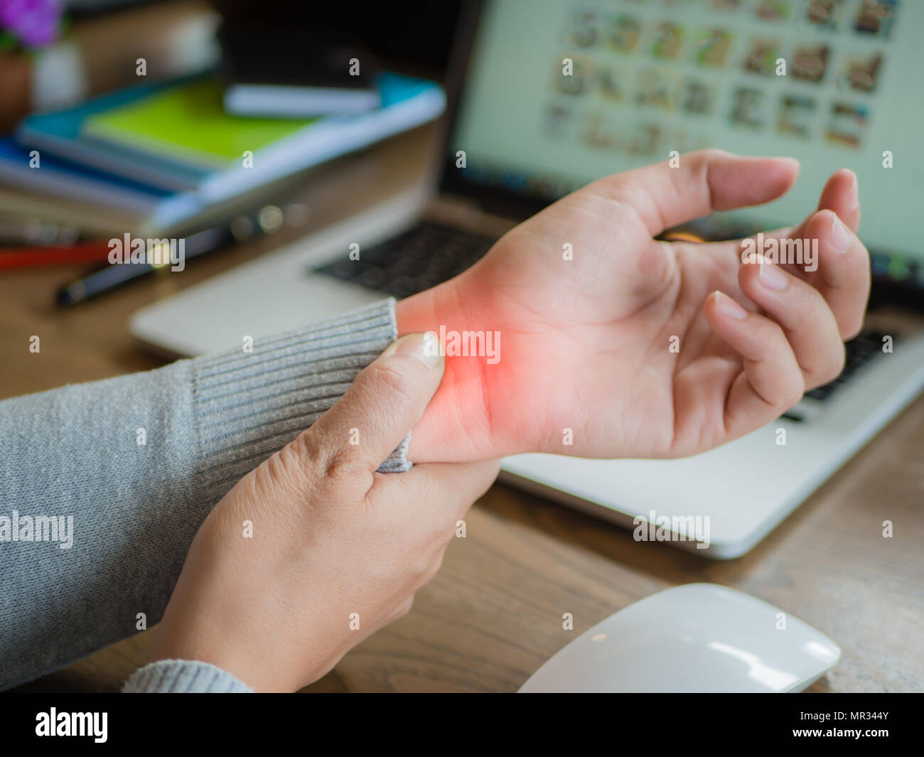 Closeup woman holding her wrist pain from using computer long time ...