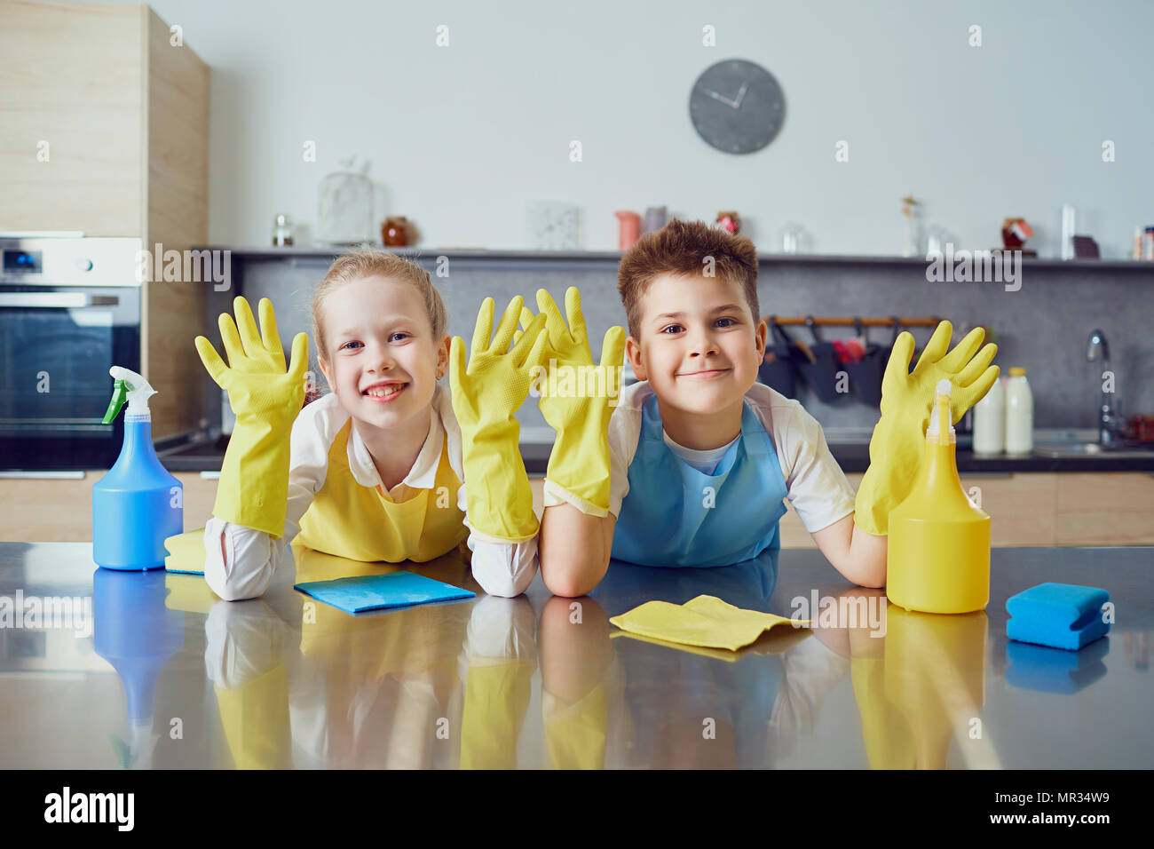 Smiling children do the cleaning in the kitchen Stock Photo - Alamy