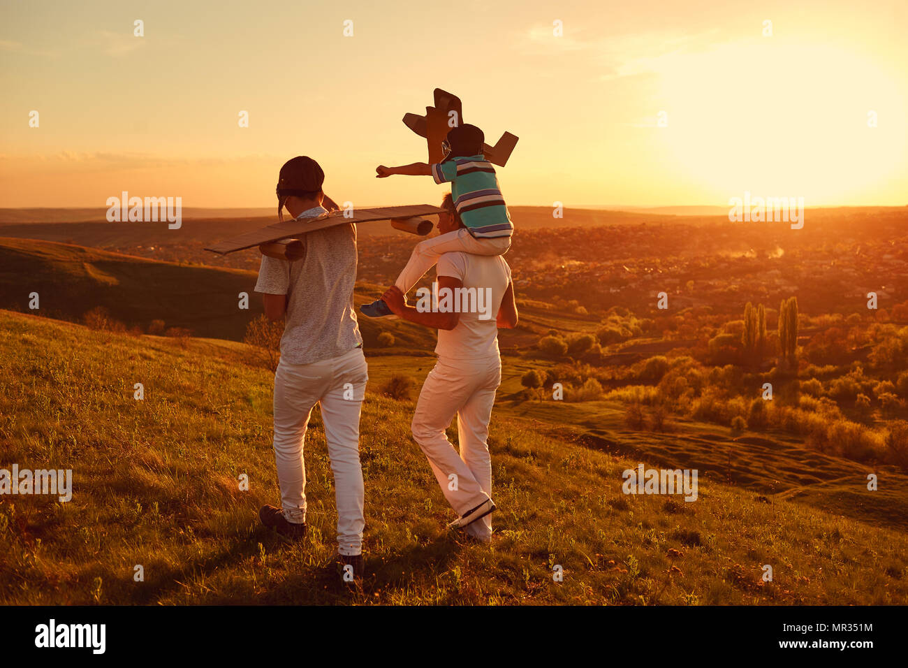 Happy family in nature at sunset Stock Photo - Alamy