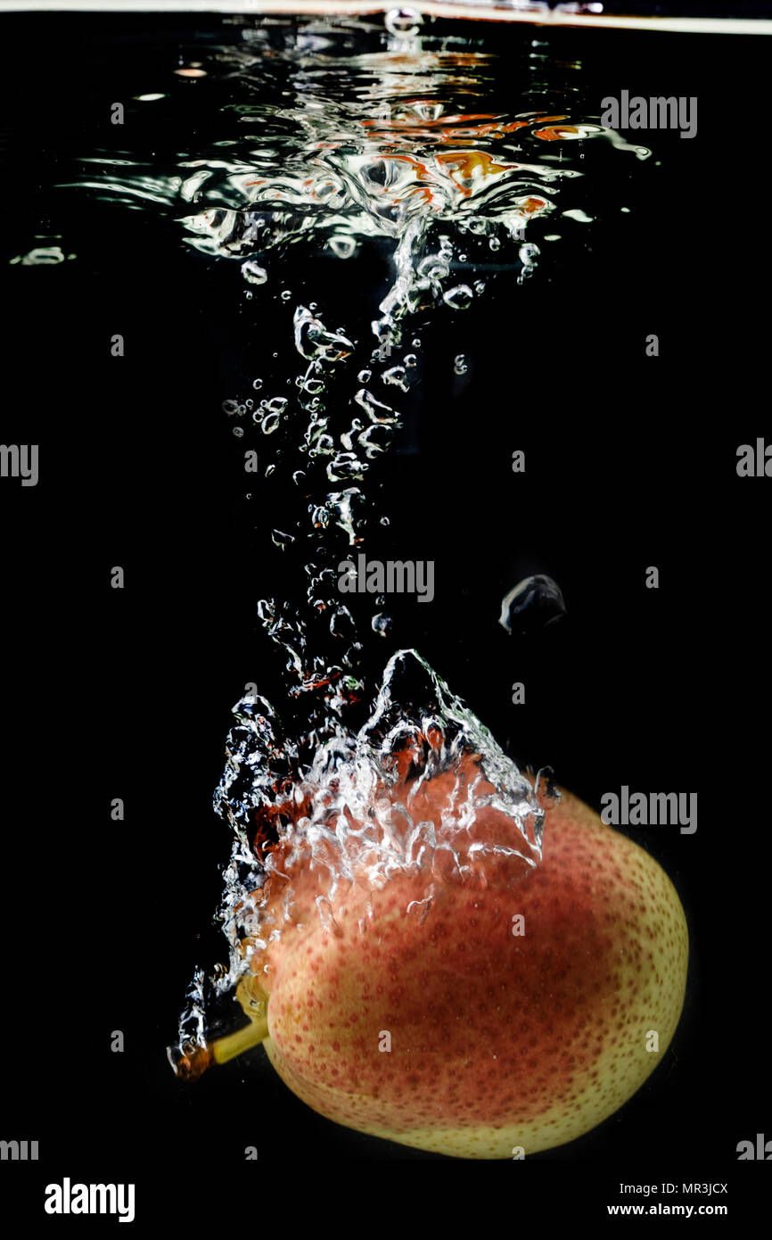 Pear surrounded by with water splash Stock Photo - Alamy