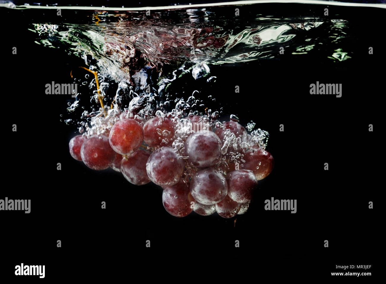 Red grapes with water splash Stock Photo - Alamy