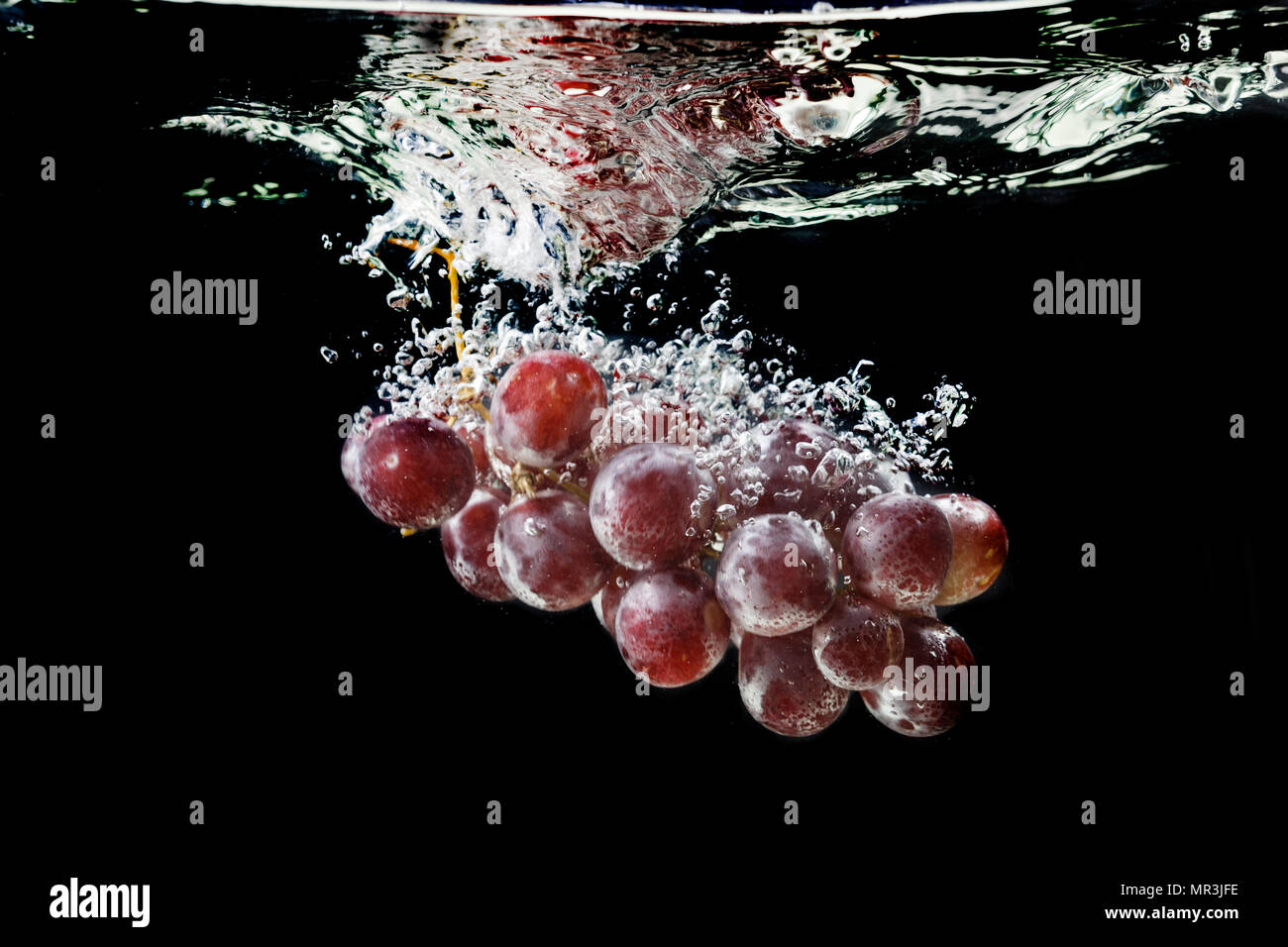 Red grapes with water splash Stock Photo - Alamy