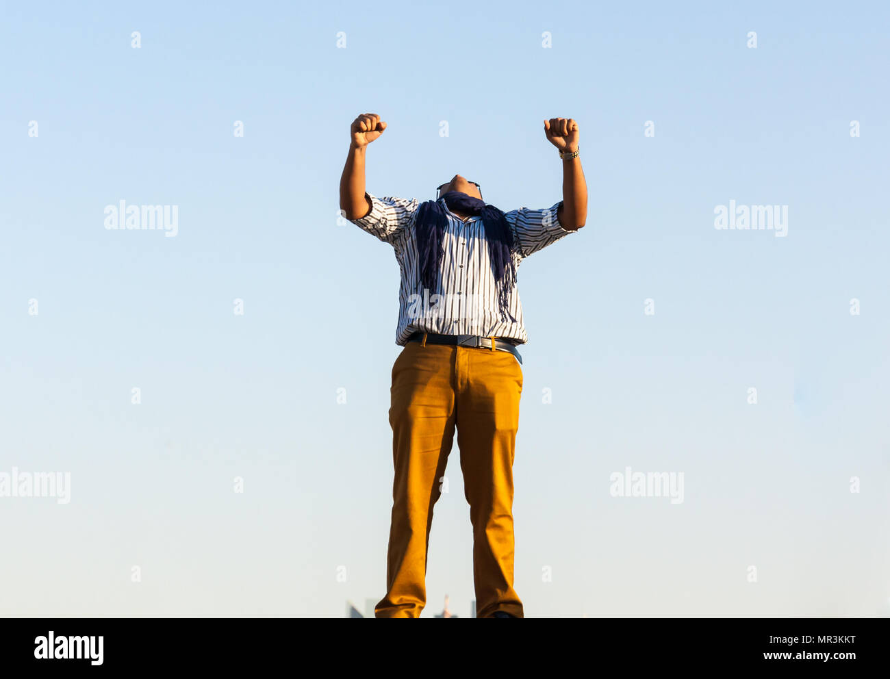 Man wearing casual dress with shawl ,showing hurrah sign with both his ...