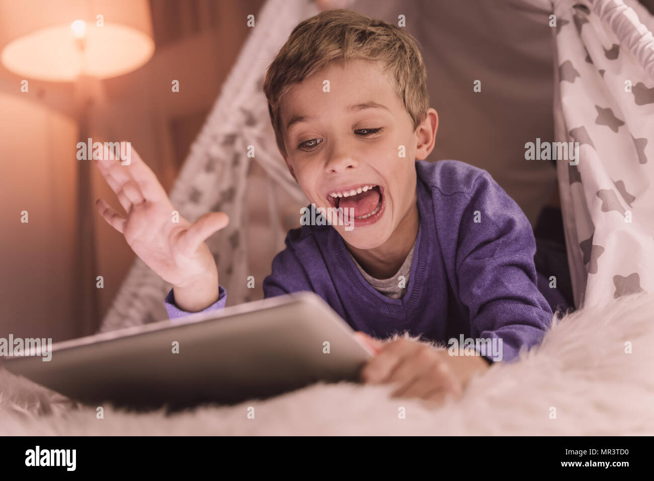 Happy cute boy making an online call Stock Photo - Alamy