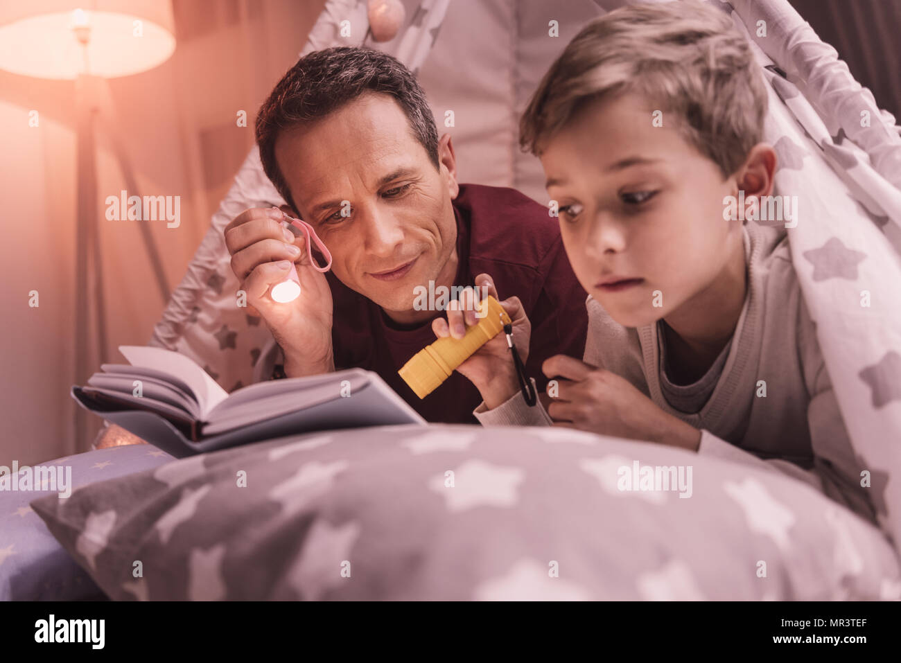 Child parent reading flashlight hi-res stock photography and images - Alamy