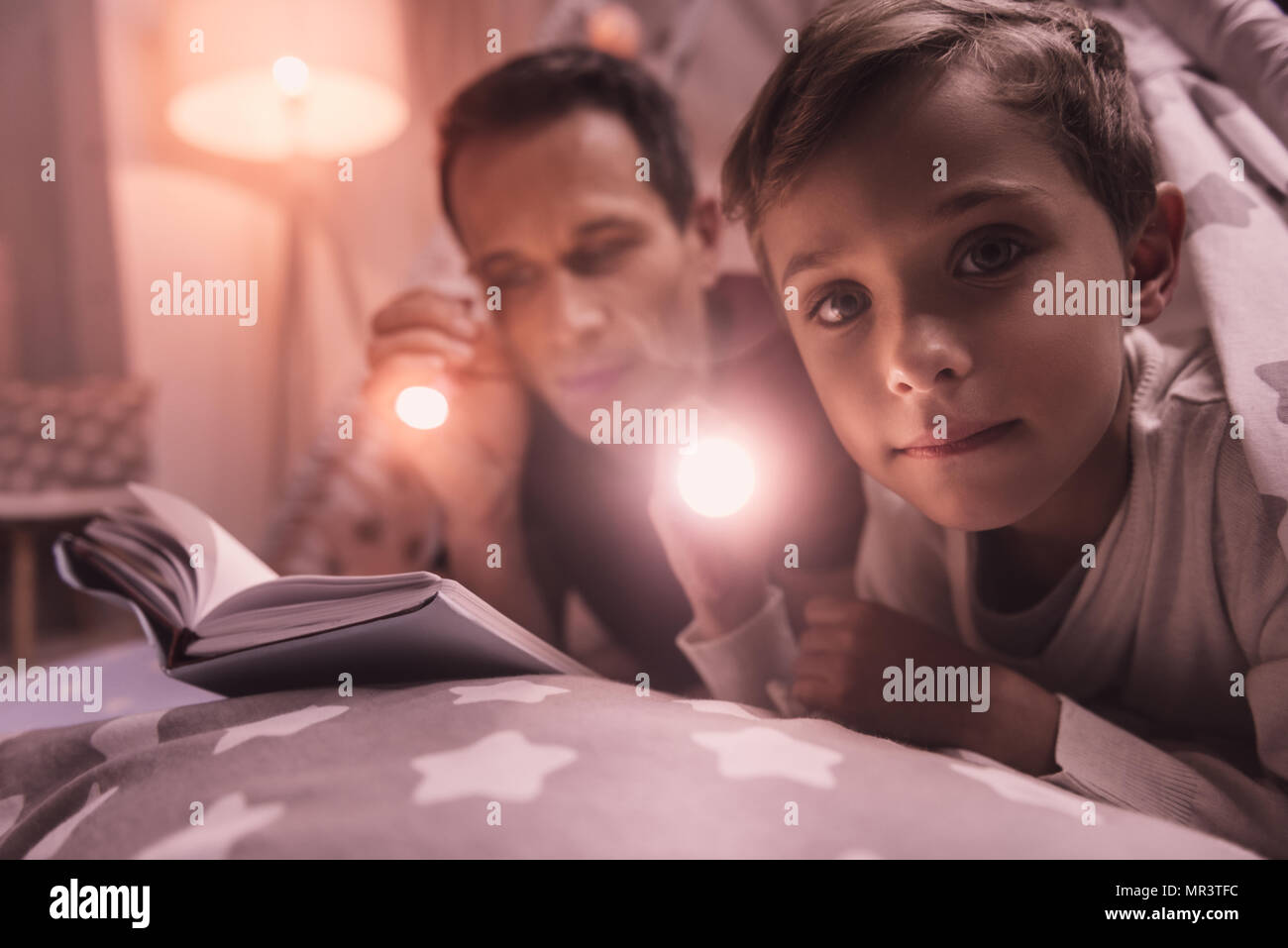 Child parent reading flashlight hi-res stock photography and images - Alamy