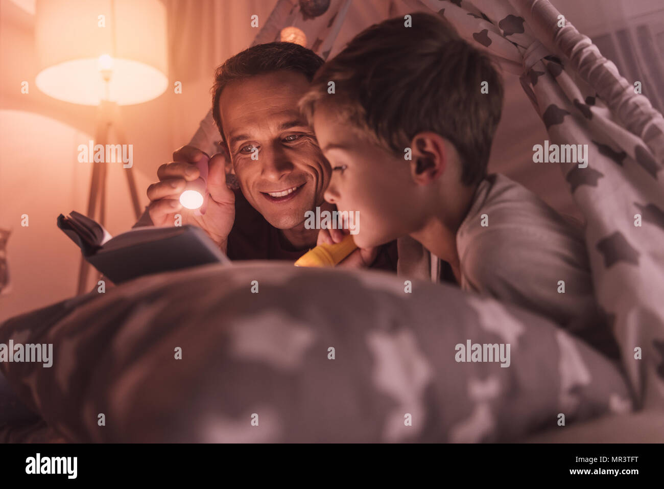 Child parent reading flashlight hi-res stock photography and images - Alamy