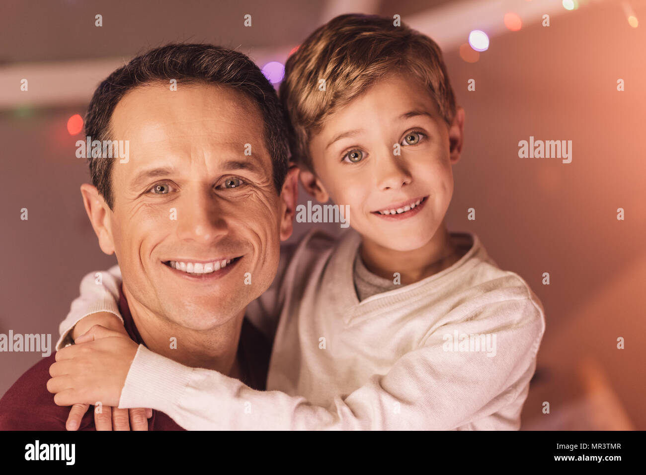 Nice cute boy hugging his father Stock Photo - Alamy