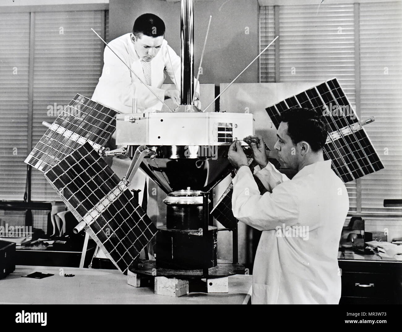Photograph taken of scientists working on the S-3 spacecraft's final ...