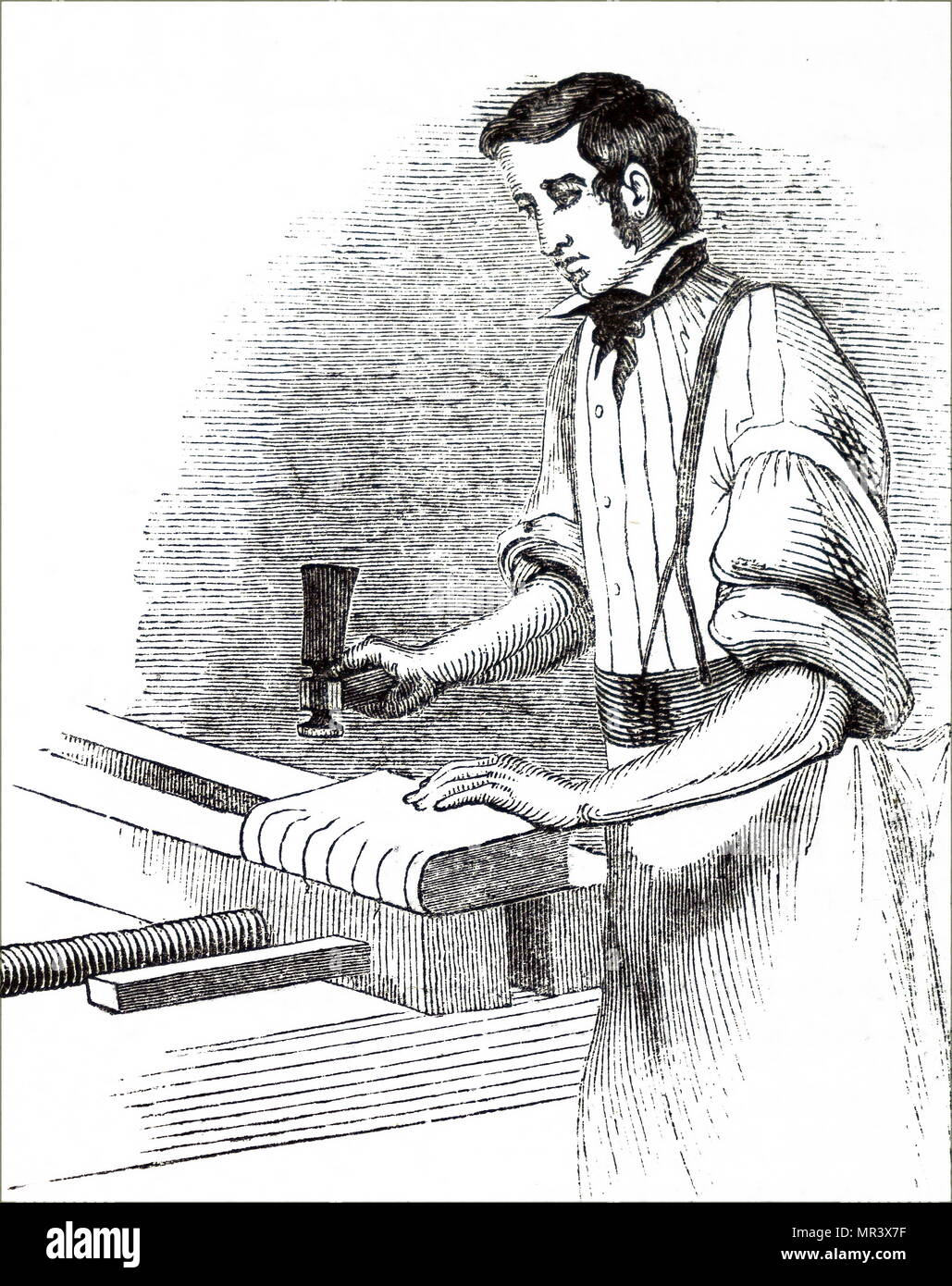 Engraving depicting a process in bookbinding: rounding the back of sewn ...