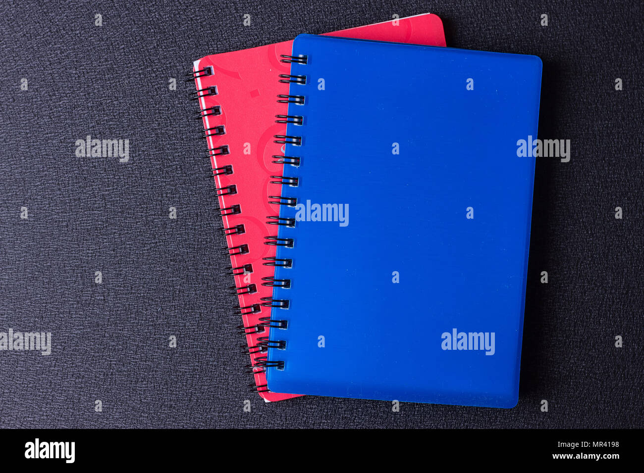 Several multi-colored notebooks on a spiral on a black background Stock ...