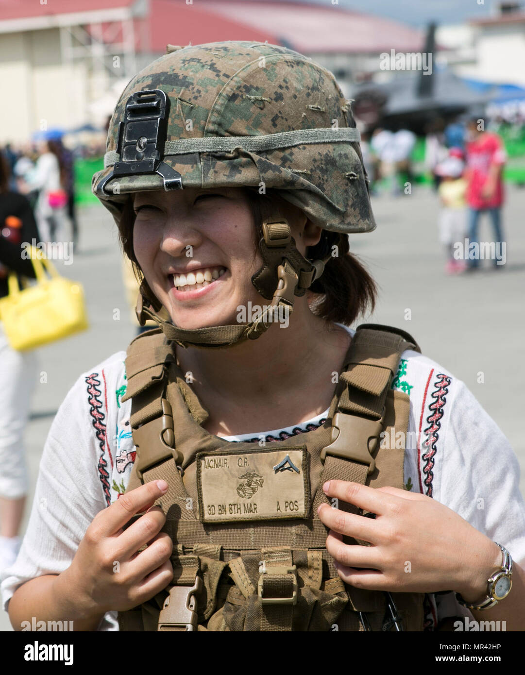 A Japanese local national poses for a photo in flak jacket and kevlar ...