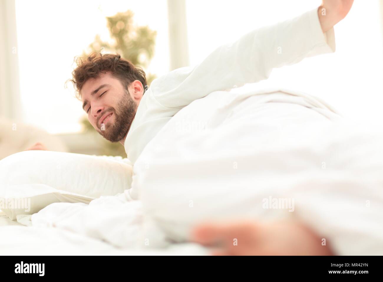 closeup.tired men asleep on the bed Stock Photo - Alamy