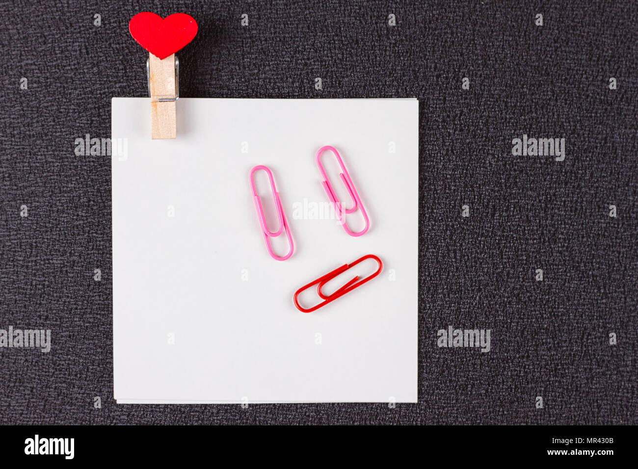 white sticker attached drawing pin on the black background Stock Photo ...