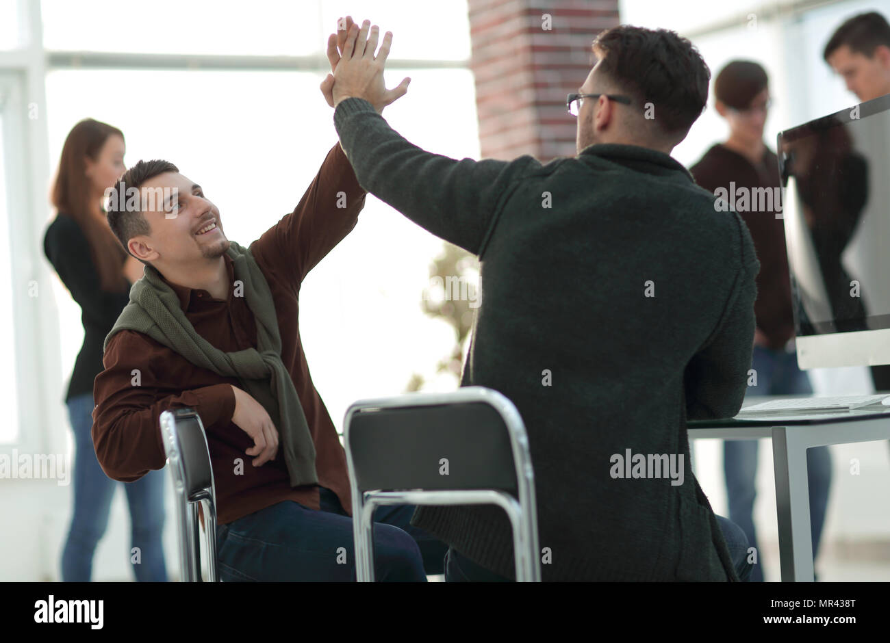 business colleagues giving each other high five Stock Photo - Alamy