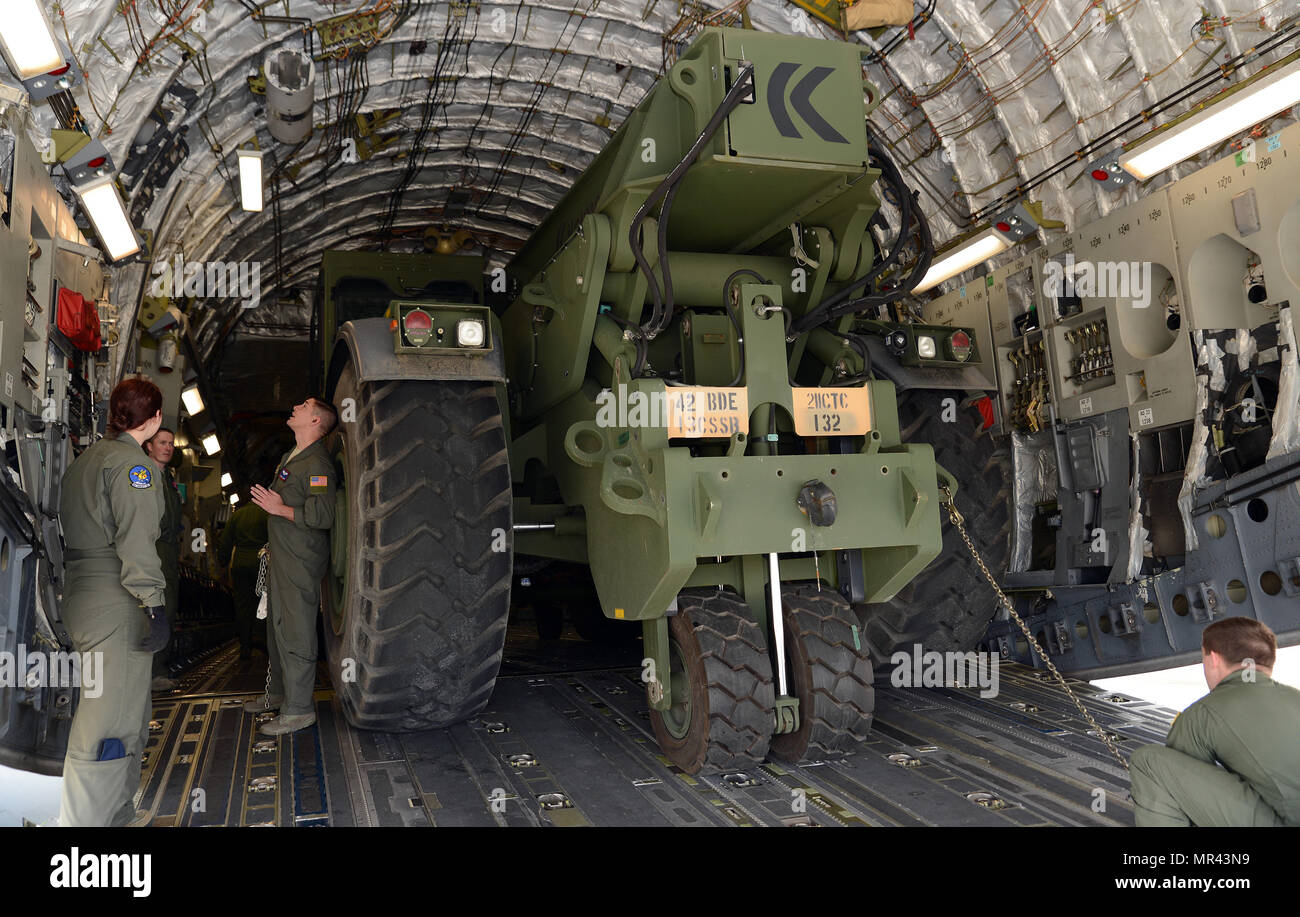 Team McChord loadmasters load a Rough Terrain Container Handler in a C ...