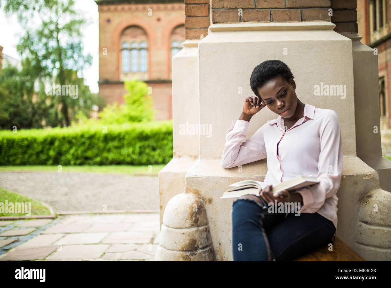 smart african uni student reading a book Stock Photo - Alamy