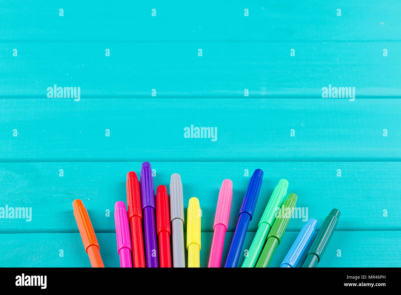 Colorful marker pen set on blue background Stock Photo - Alamy