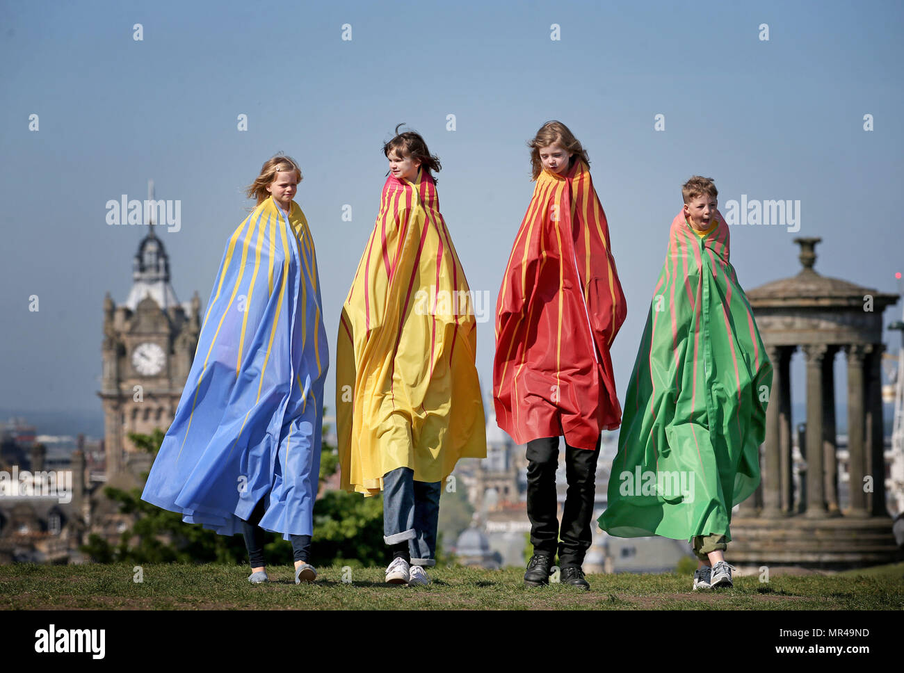 Dressed in giant capes (from left) Sofia Allison, four, Lottie Steel, four, Bella Linehan, five ...