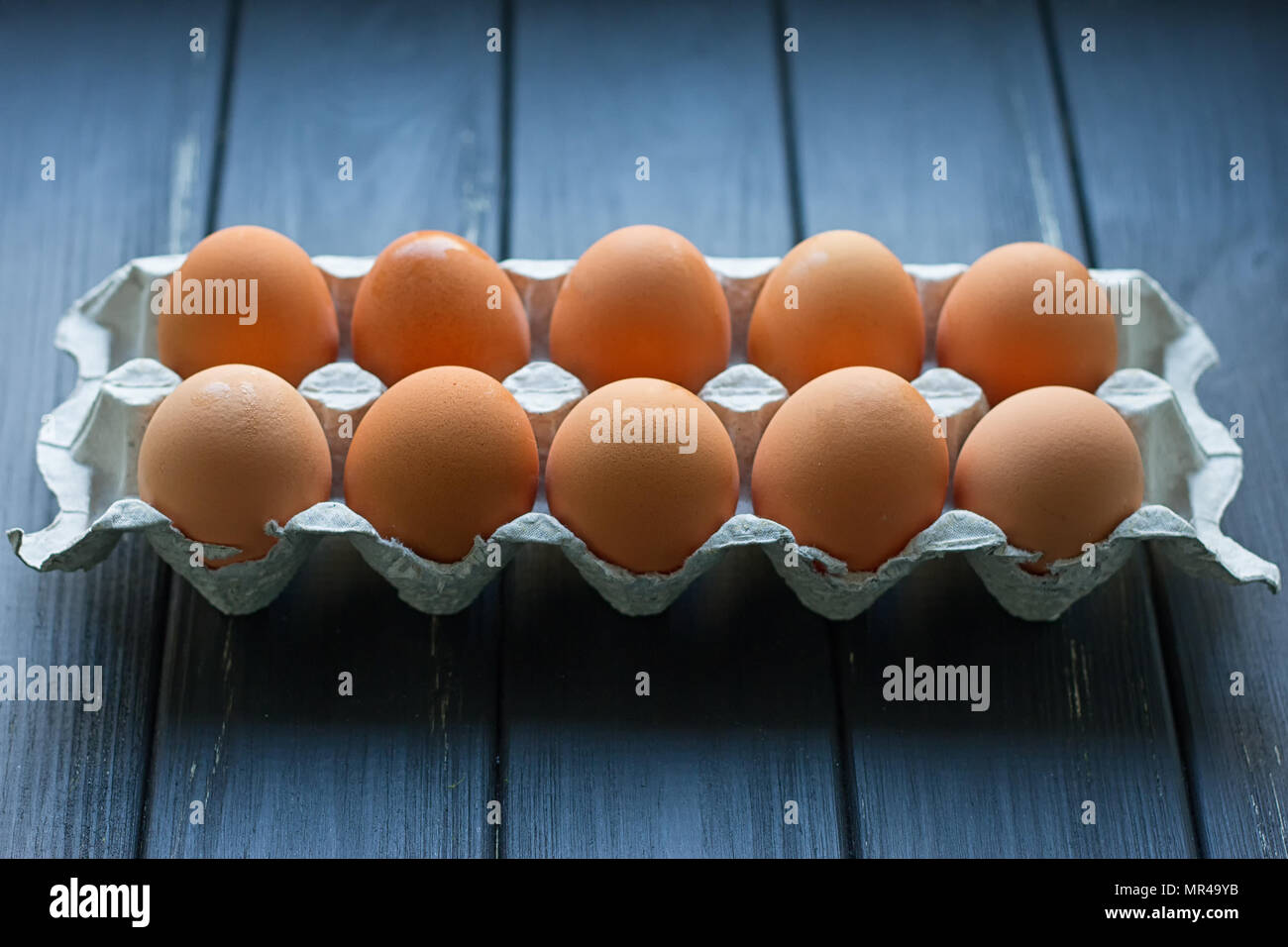 Cardboard egg box on black wooden background. Eggs container Stock ...