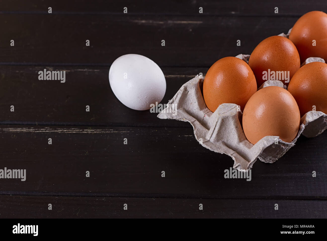 Cardboard egg box on black wooden background. Eggs container Stock ...