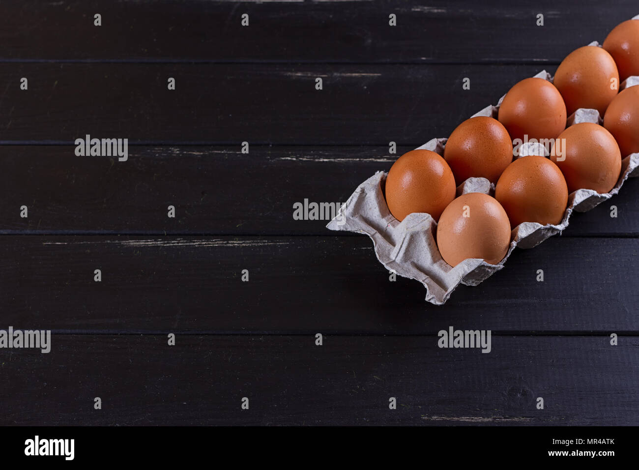 Cardboard egg box on black wooden background. Eggs container Stock ...