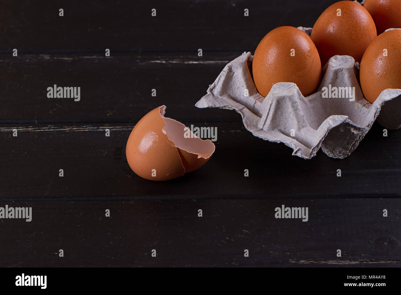 Cardboard egg box And eggshell shells on black wooden background. Eggs ...