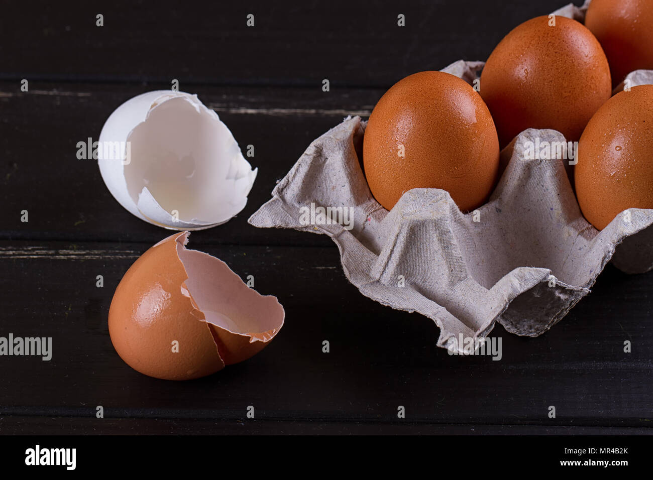 Cardboard egg box And eggshell shells on black wooden background. Eggs ...