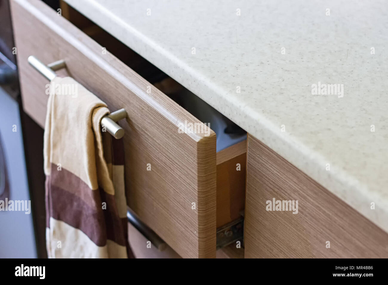 A pull-out kitchen box in the kitchen and a brown towel Stock Photo - Alamy