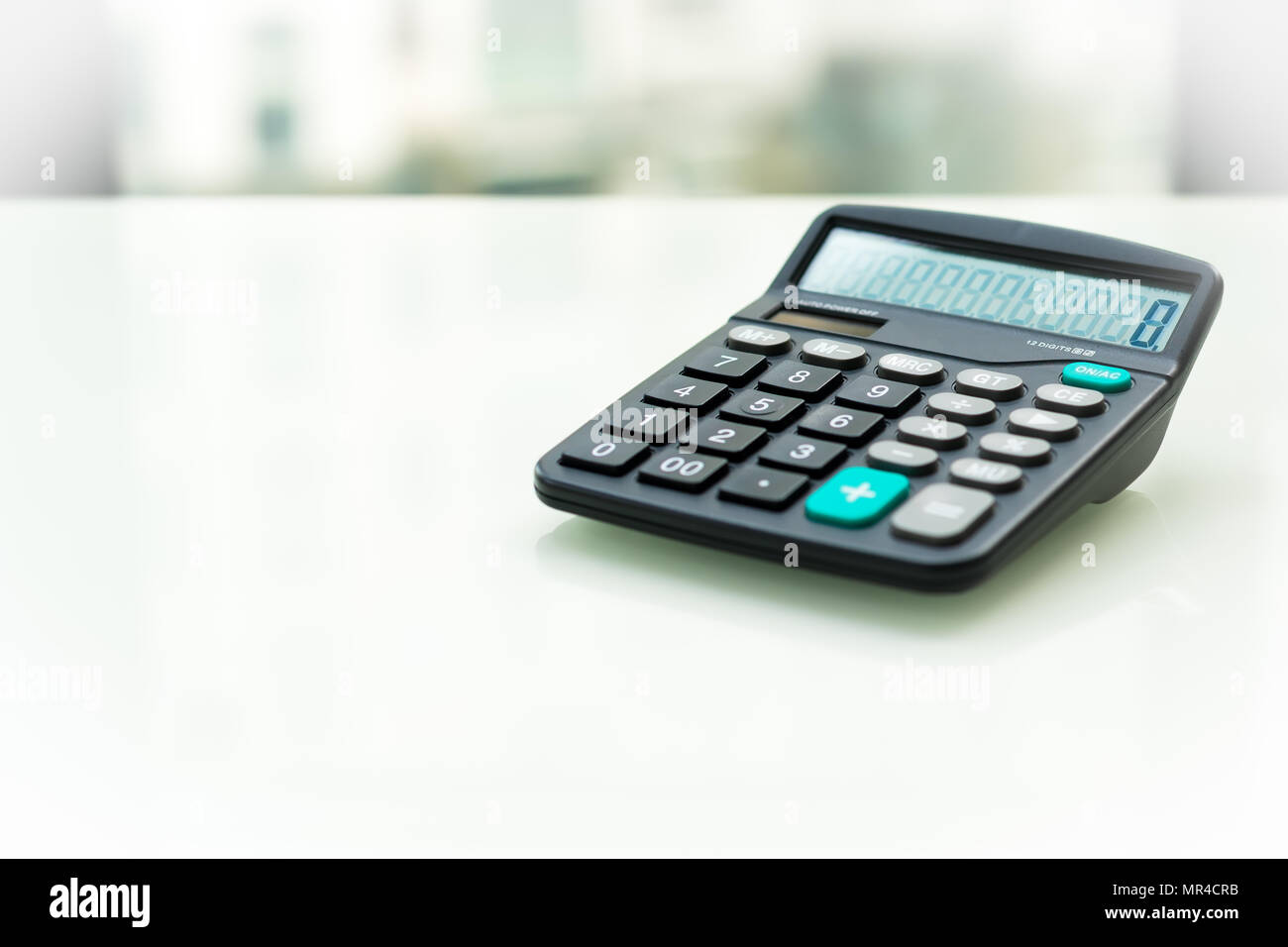 Calculator on the white table near window, sideview isolated Stock ...