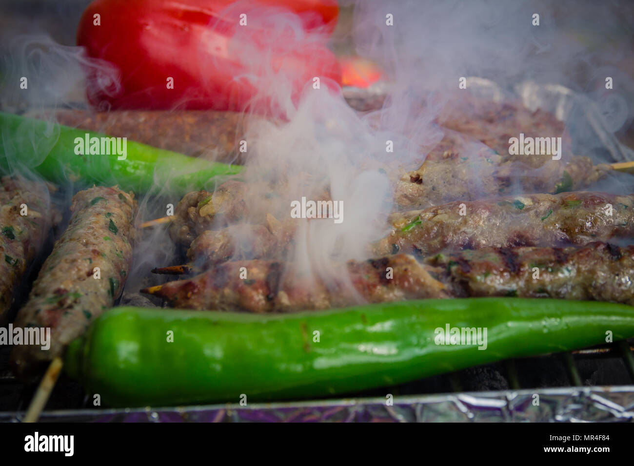 Different types of meat are cooked on the grill - close up Stock Photo ...