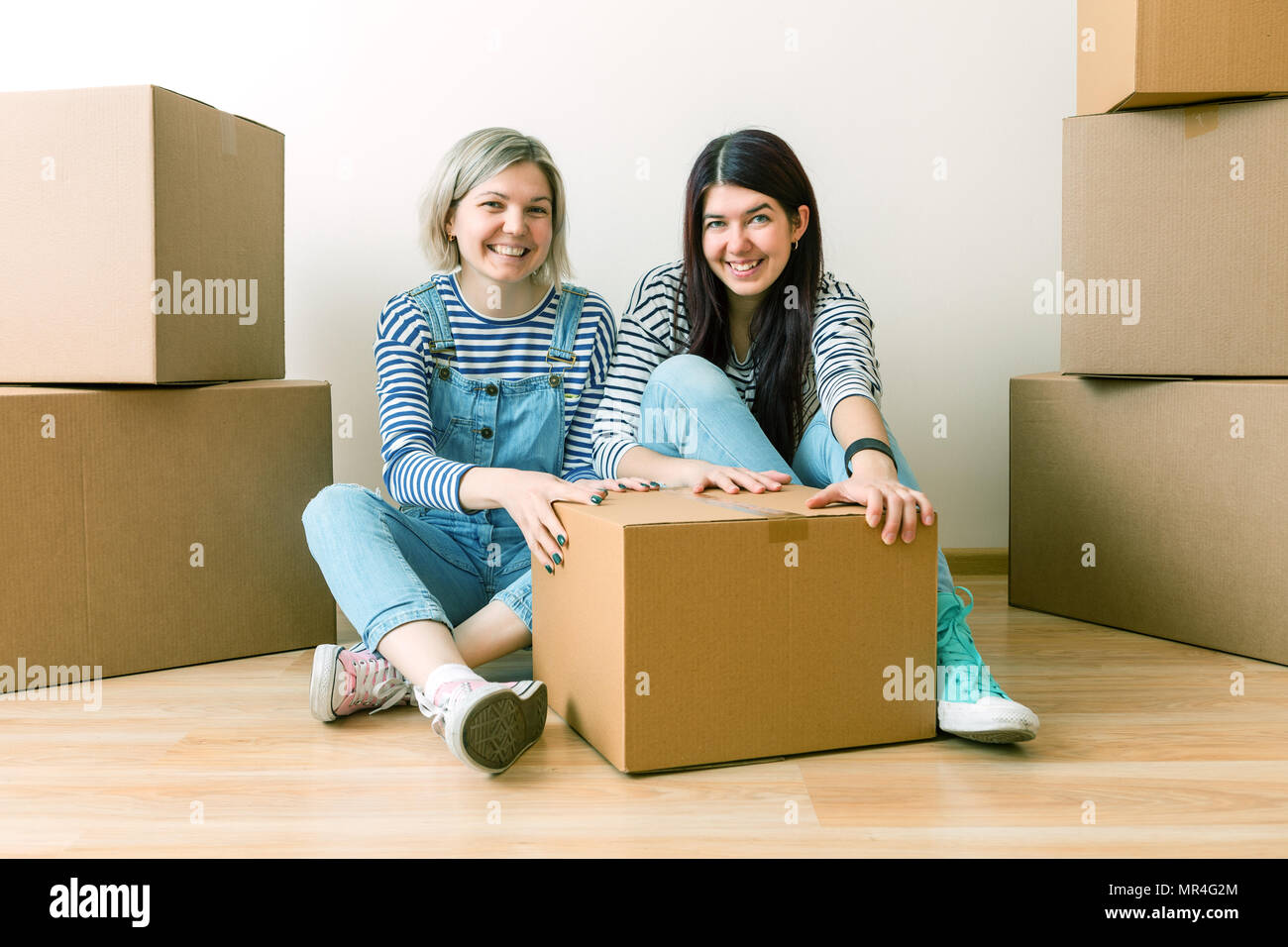 Photo of two women among cardboard boxes Stock Photo - Alamy
