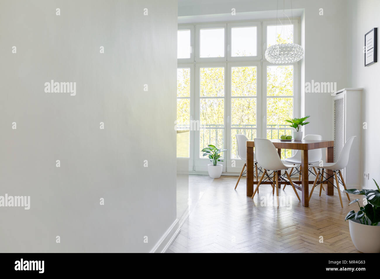 Copy space on white wall in bright dining room interior with chairs at ...