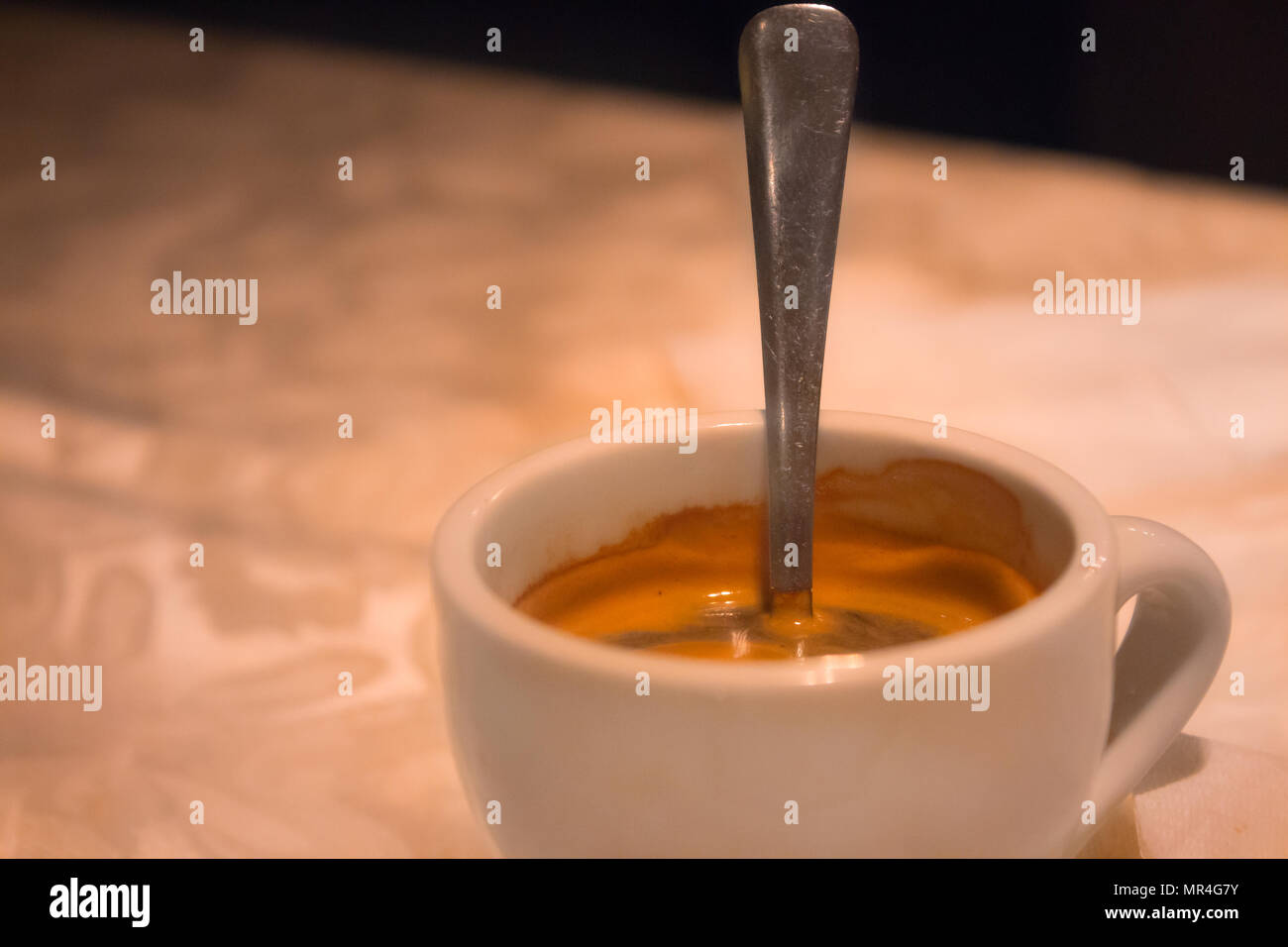 Cup of hot coffee with spoon in it Stock Photo - Alamy