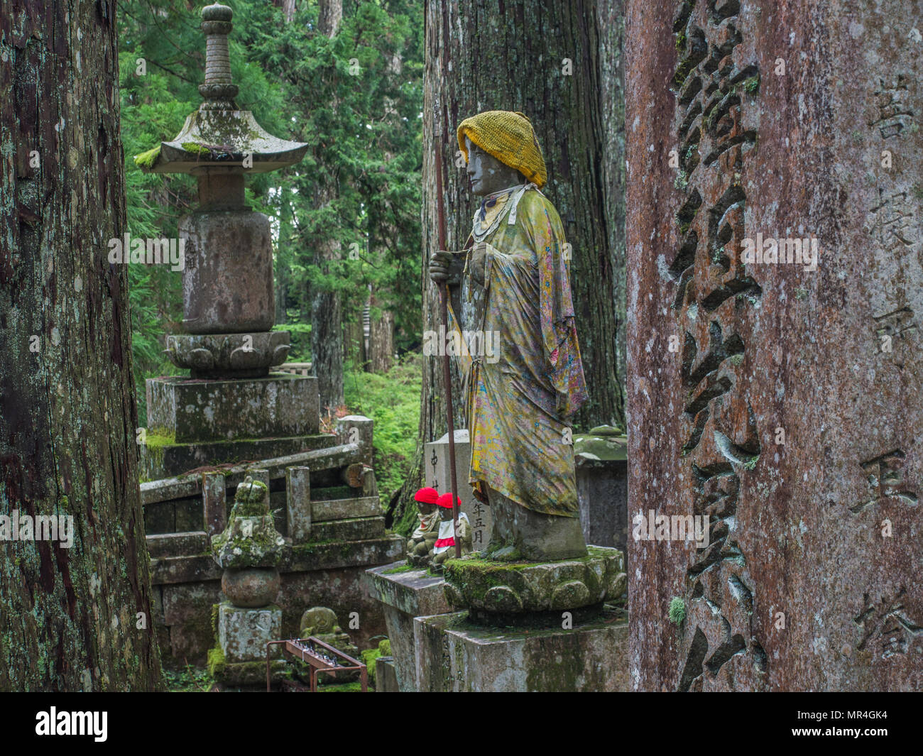 Memorial stone and statues of buddhist deities, with giant sugi trees ...