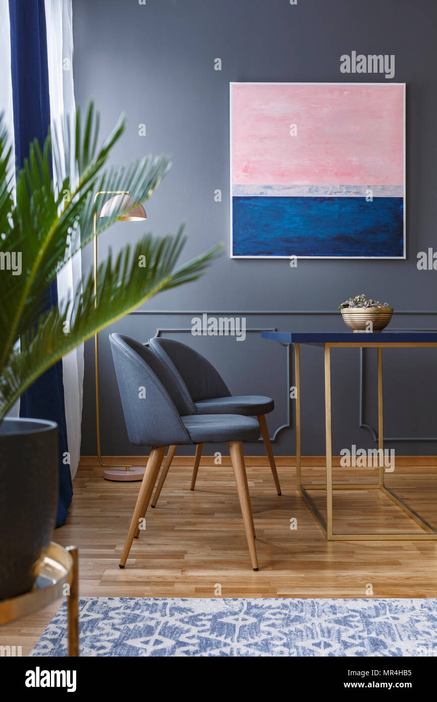 Real photo of dining room interior with two chairs standing in front of ...