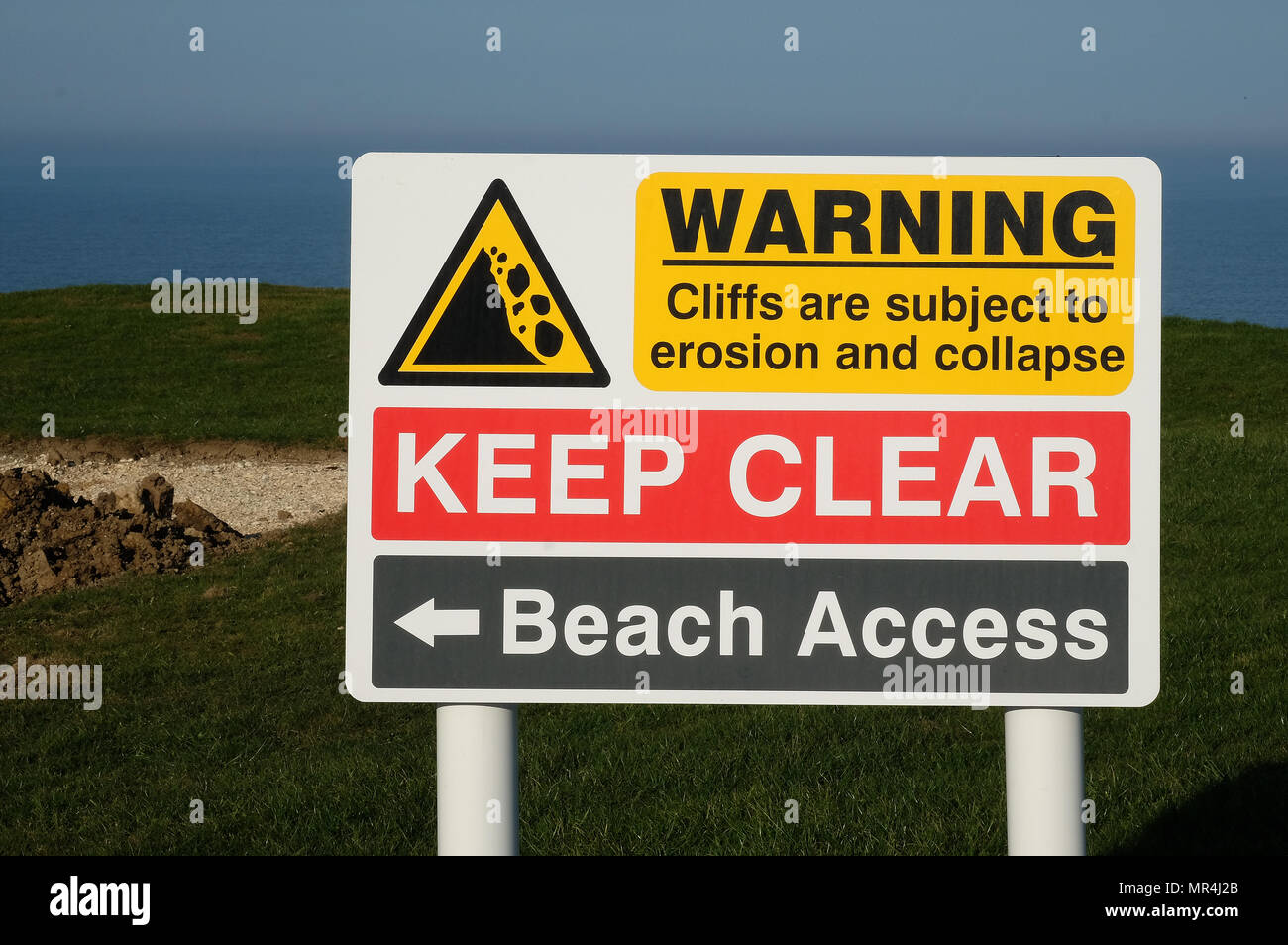 Danger sign for fast eroding clay cliffs on east coast of Yorkshire, UK ...