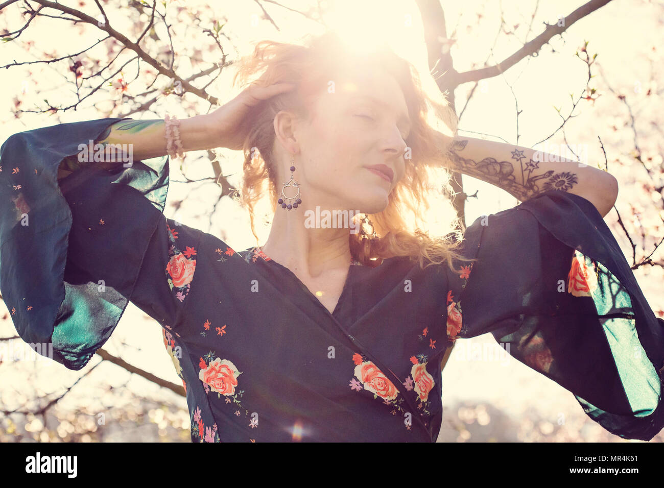 Beautiful woman in spring light garden Stock Photo - Alamy
