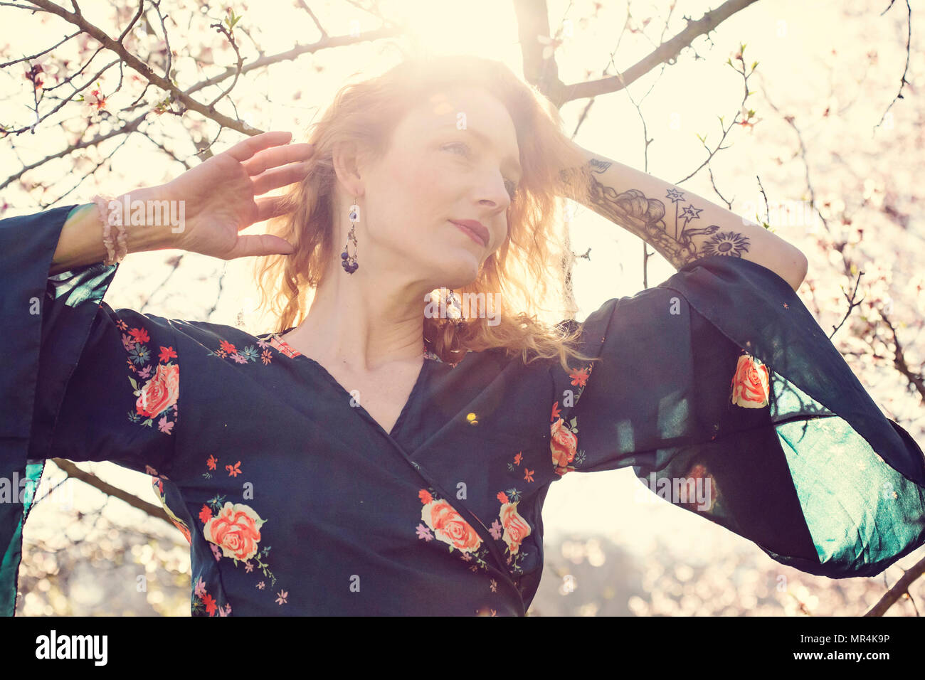 Beautiful woman in spring light garden Stock Photo - Alamy